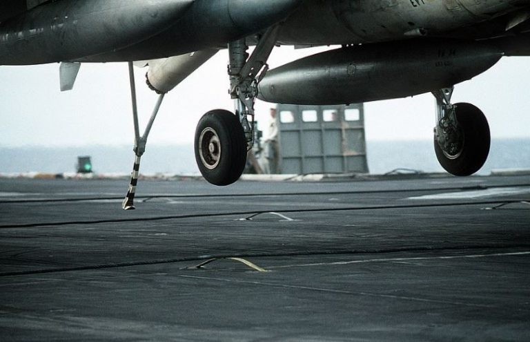 How do planes take off and land on aircraft carriers?